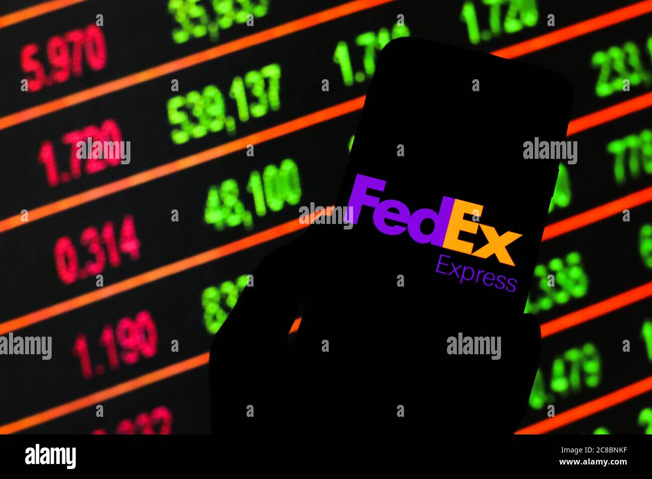 In this photo illustration a Fedex shipping company logo seen displayed ...