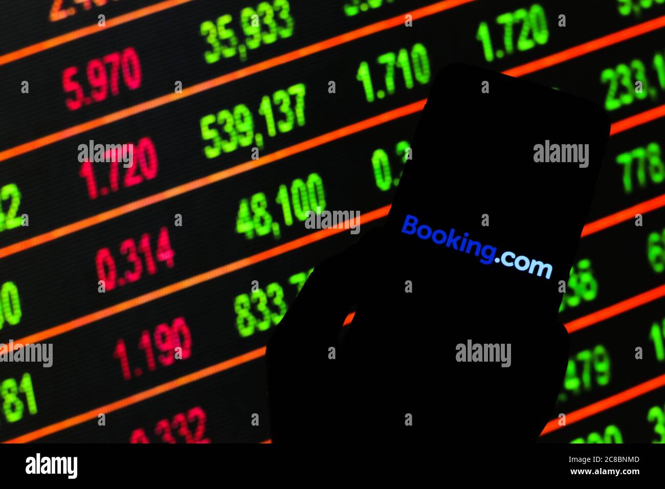 In this photo illustration a Booking.com logo seen displayed on a ...