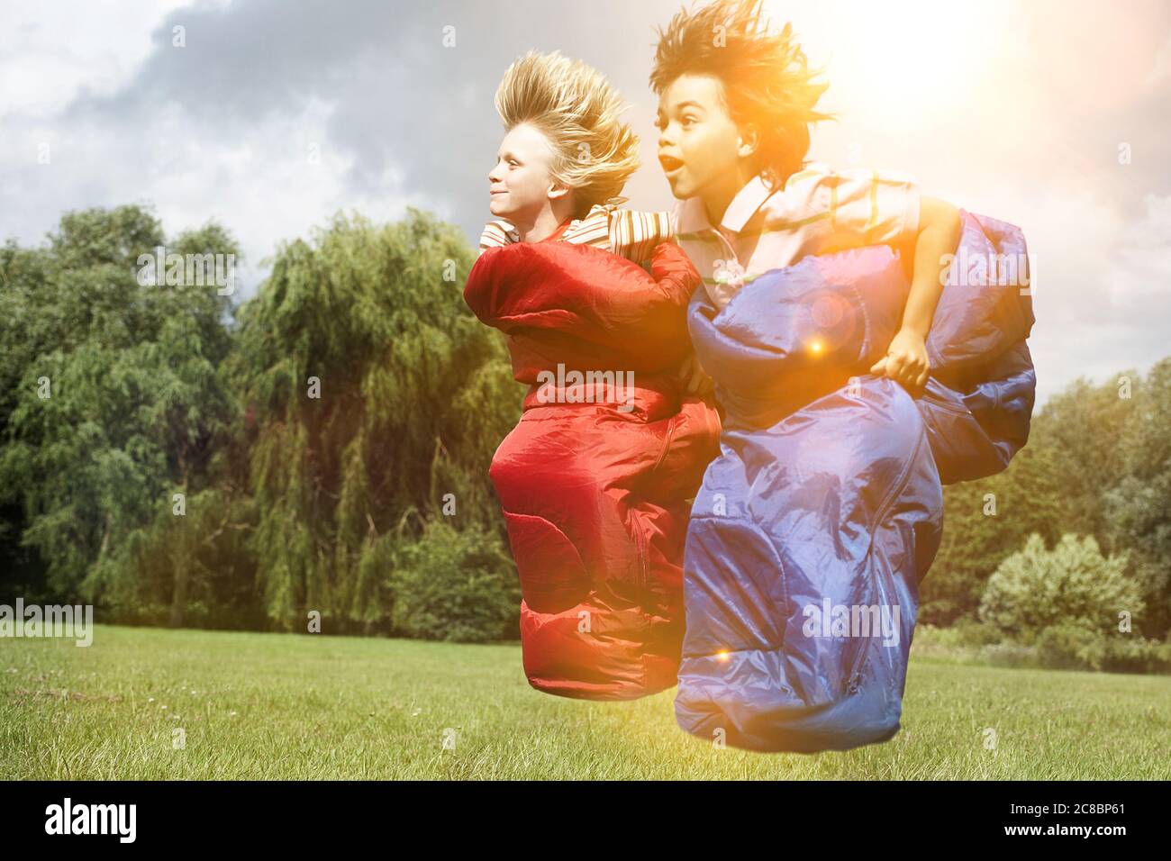 Two boys racing in sleeping bags Stock Photo - Alamy