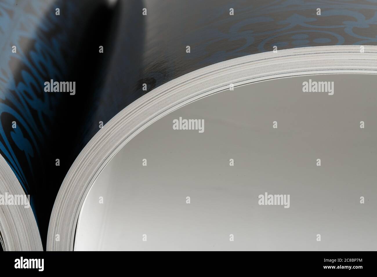Closeup shot of an open magazine on a white background Stock Photo - Alamy