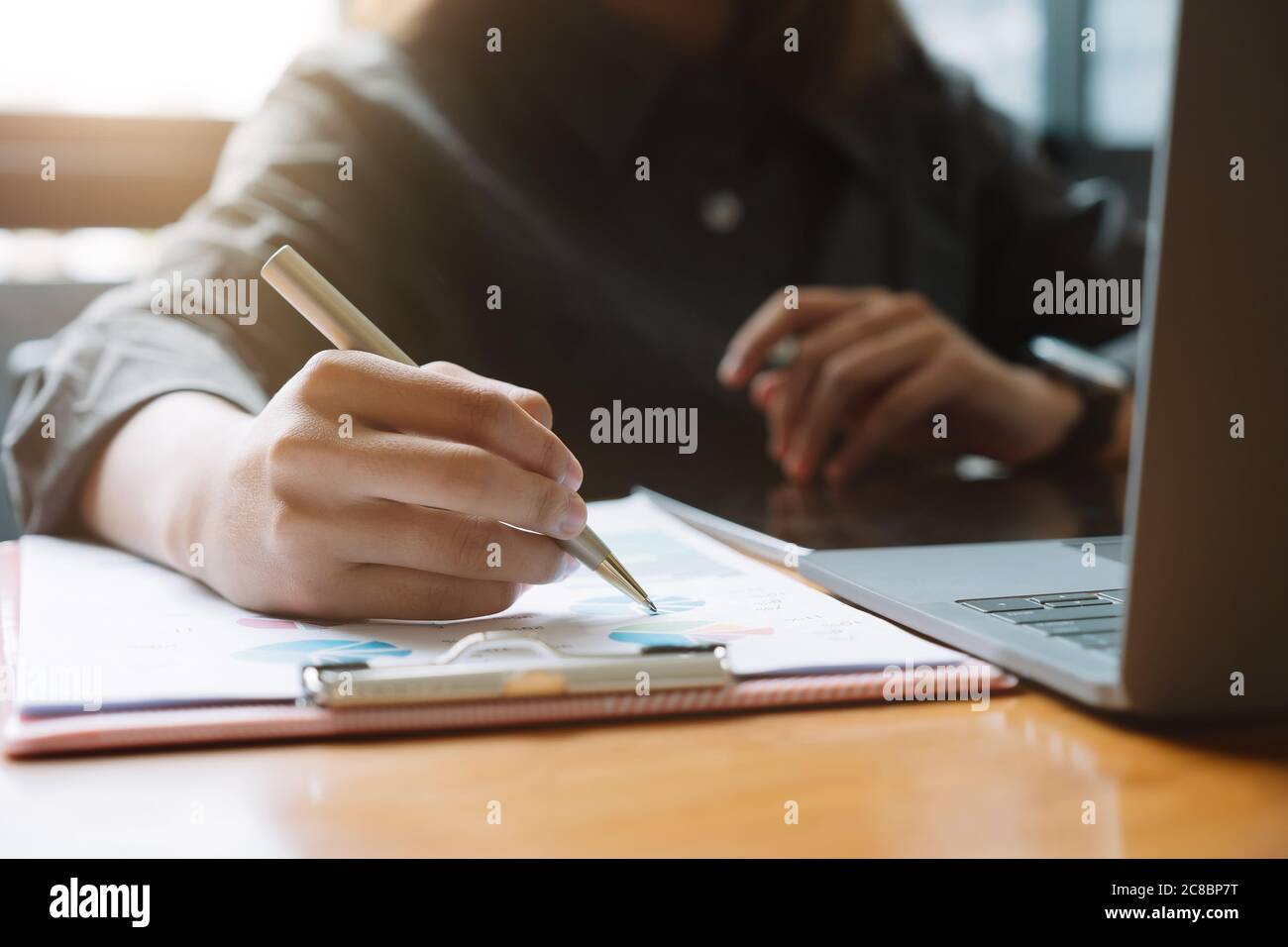 Businessman pen pointing turnover with graph chart report and use ...