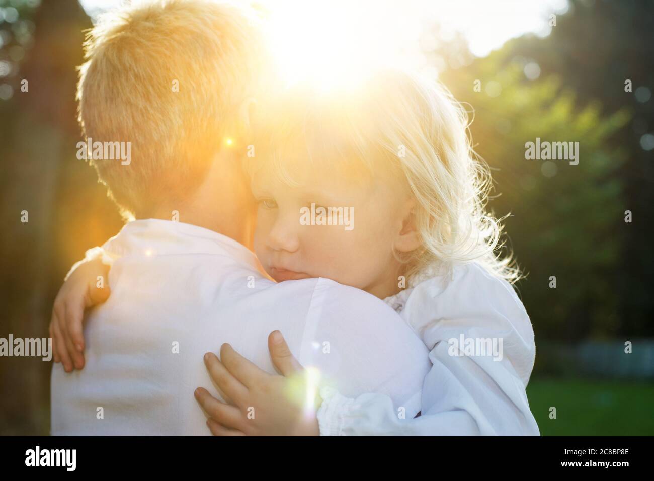 Mother hugging child in summer scene Stock Photo - Alamy