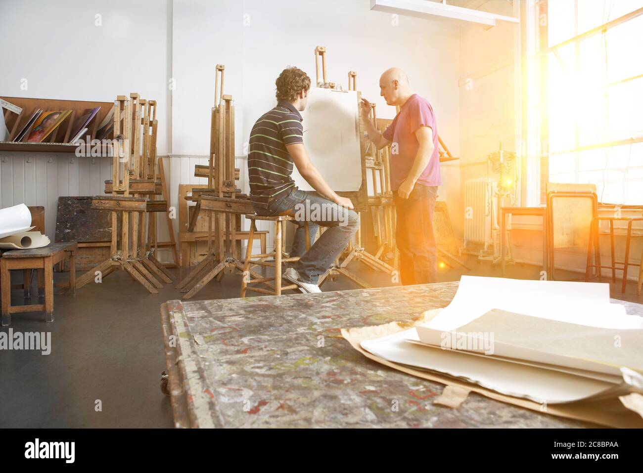 Teacher and student painting in artist studio Stock Photo - Alamy
