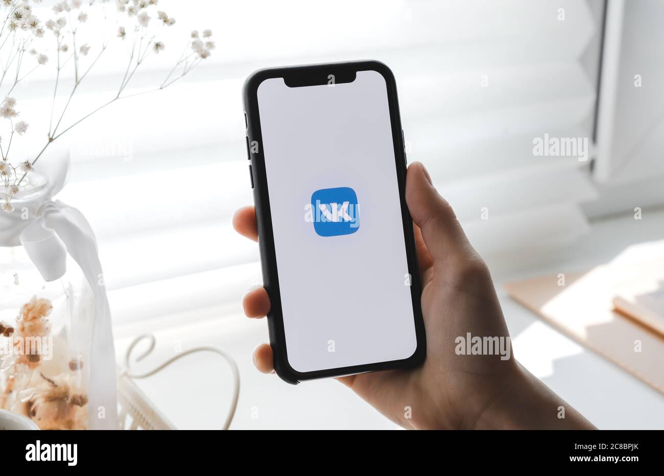 woman use VK app, logo on the screen Stock Photo - Alamy