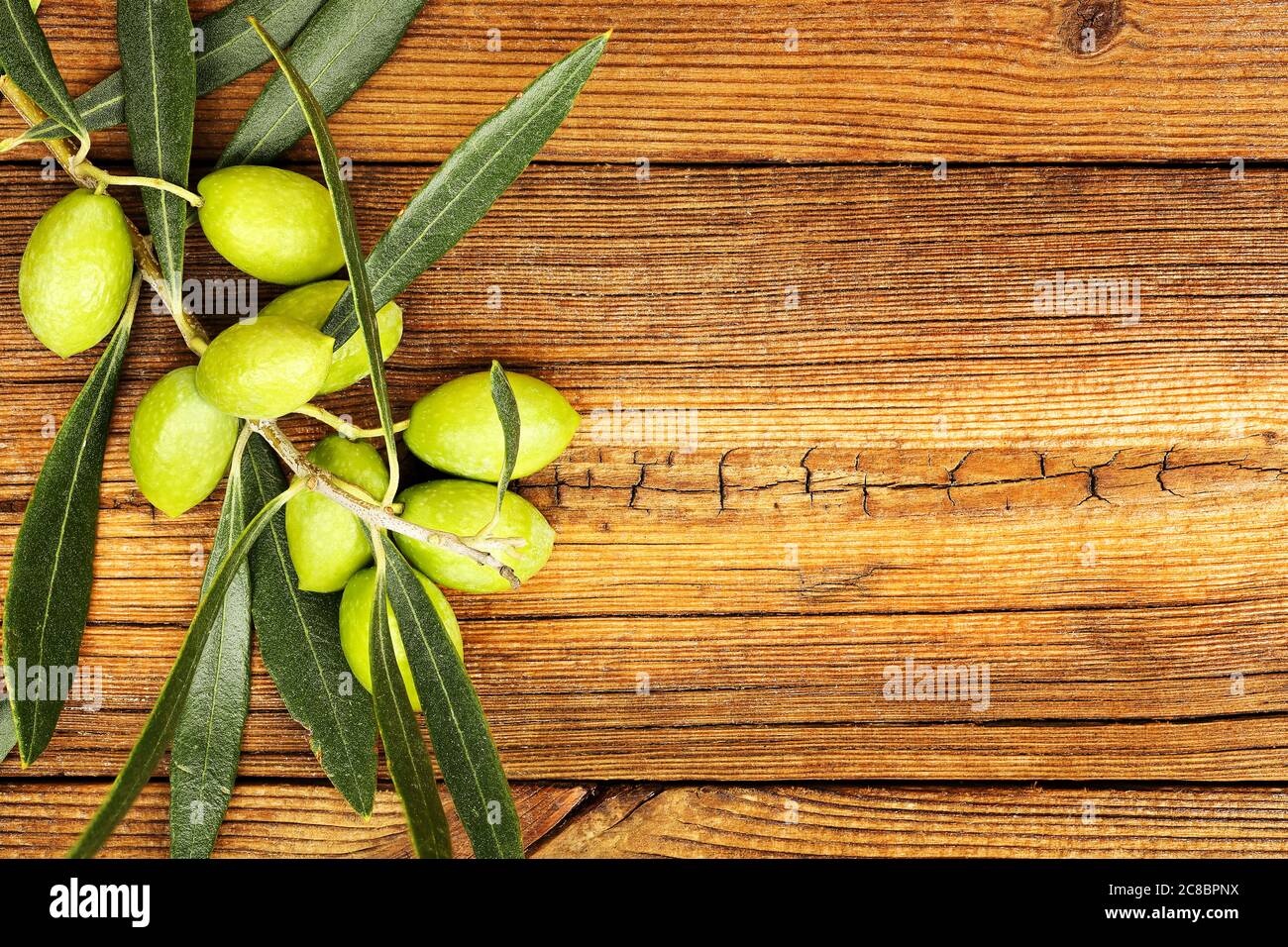 olive tree branch on old rustic wooden table Stock Photo - Alamy