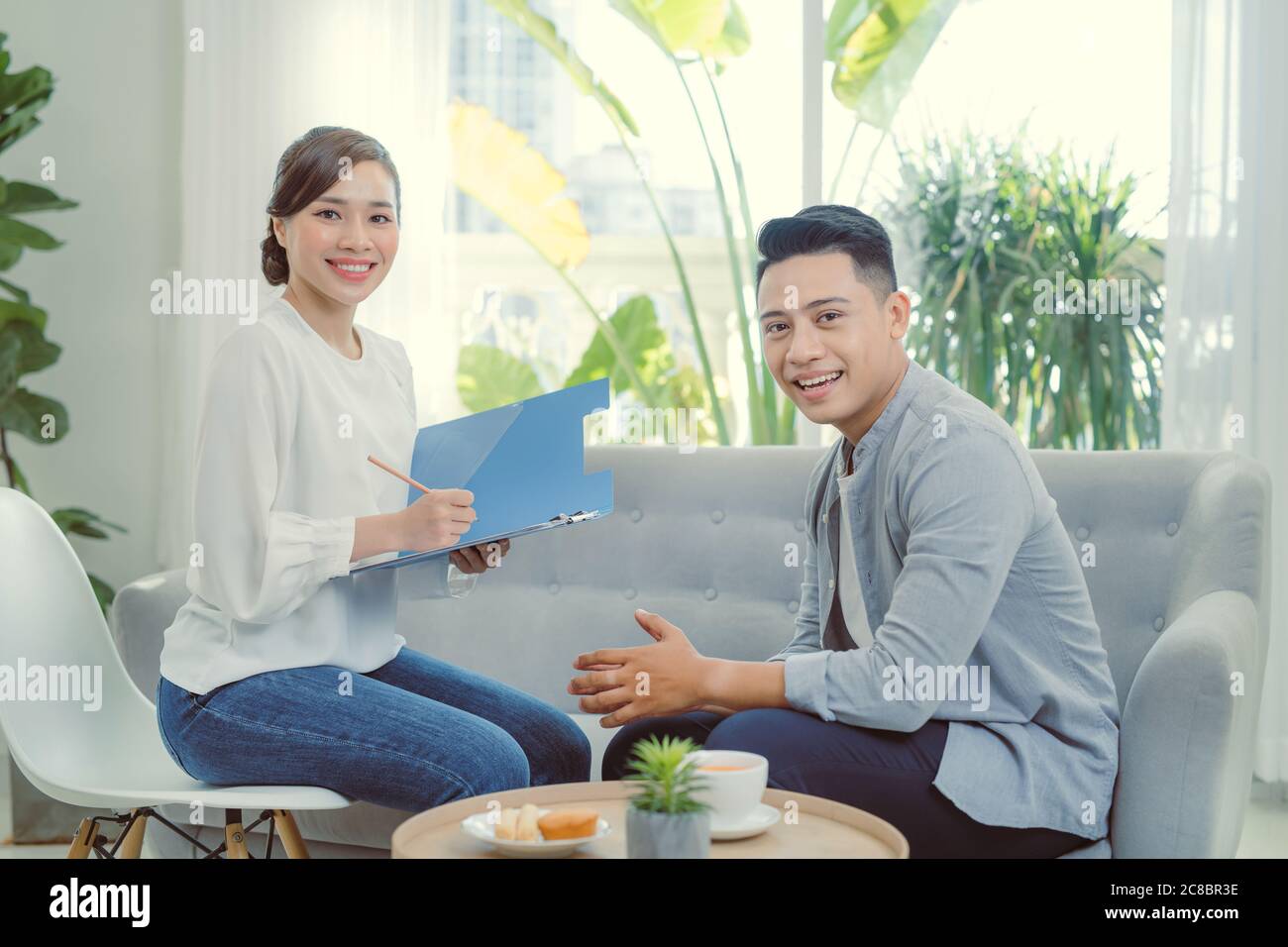 Psychologist listening to her patient and writing down notes, mental ...