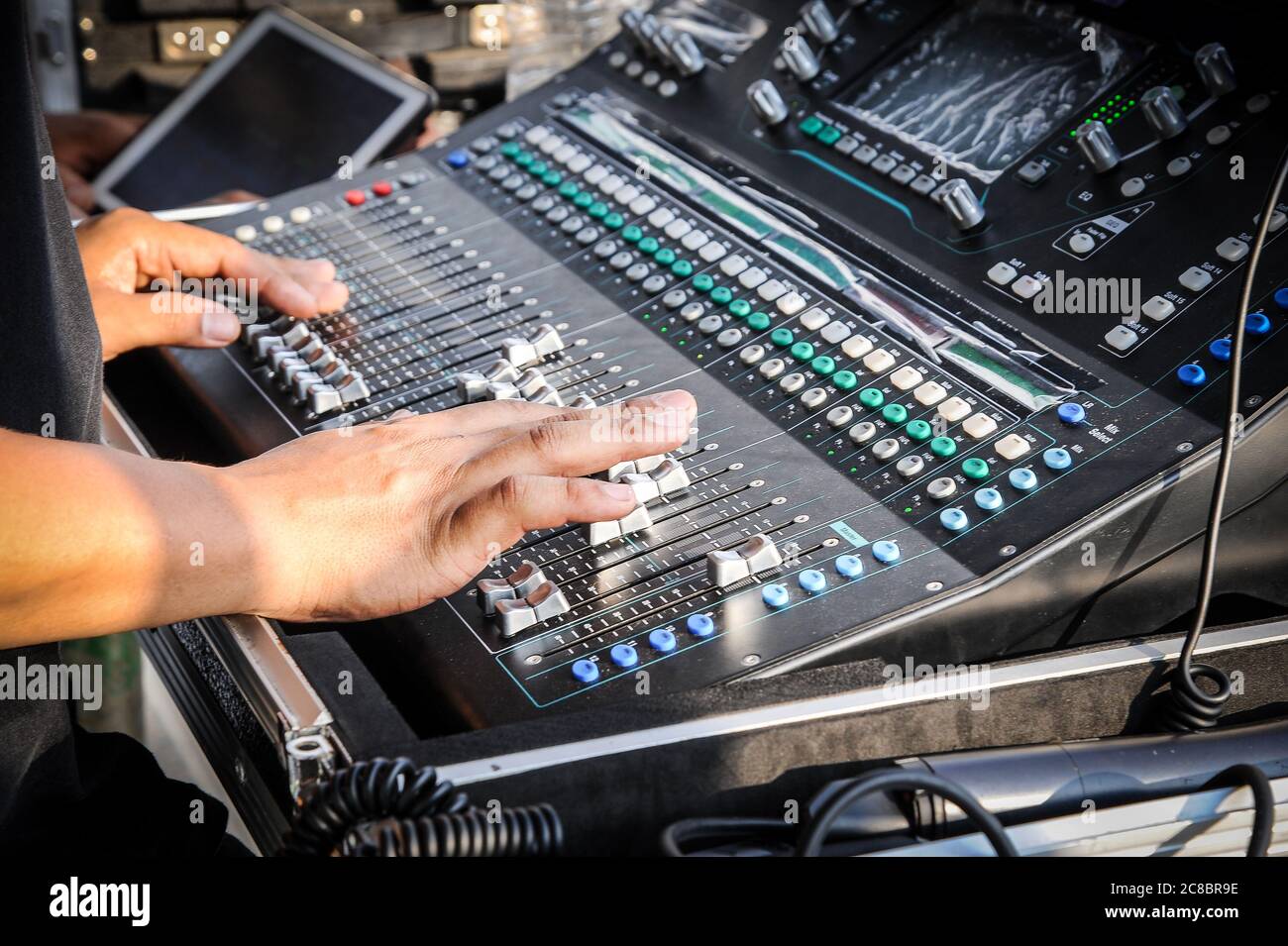 Hand adjusting on a professional audio mixer Stock Photo - Alamy