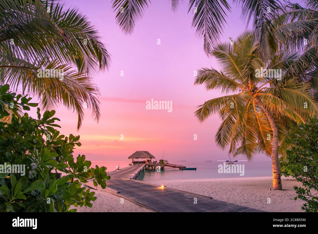Beautiful sunset beach scene. Wooden jetty colorful sky and clouds view ...