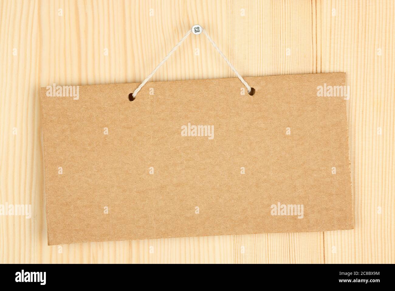 hung cardboard signboard on wooden panel Stock Photo - Alamy