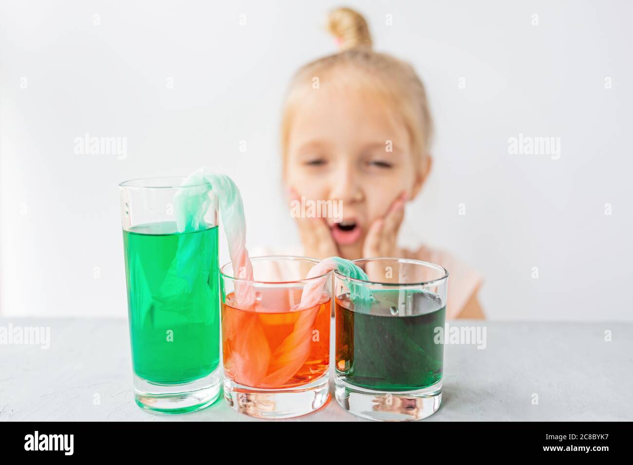 cute little girl six years old doing laboratory experiment with ...