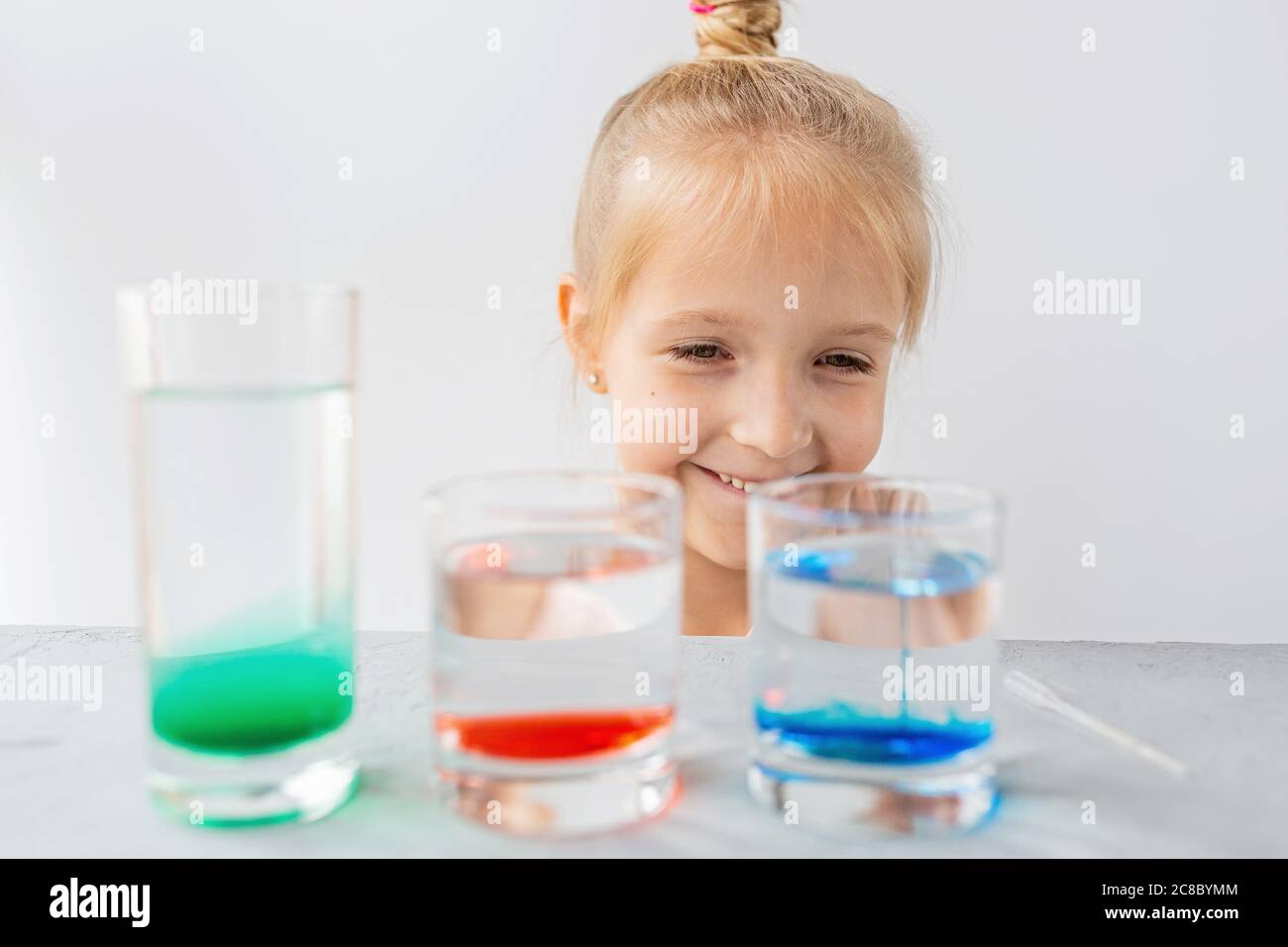 cute little girl six years old doing laboratory experiment with ...