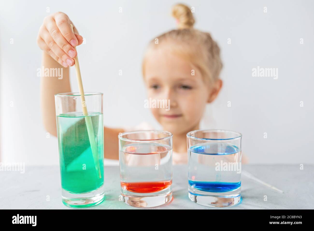 cute little girl six years old doing laboratory experiment with ...