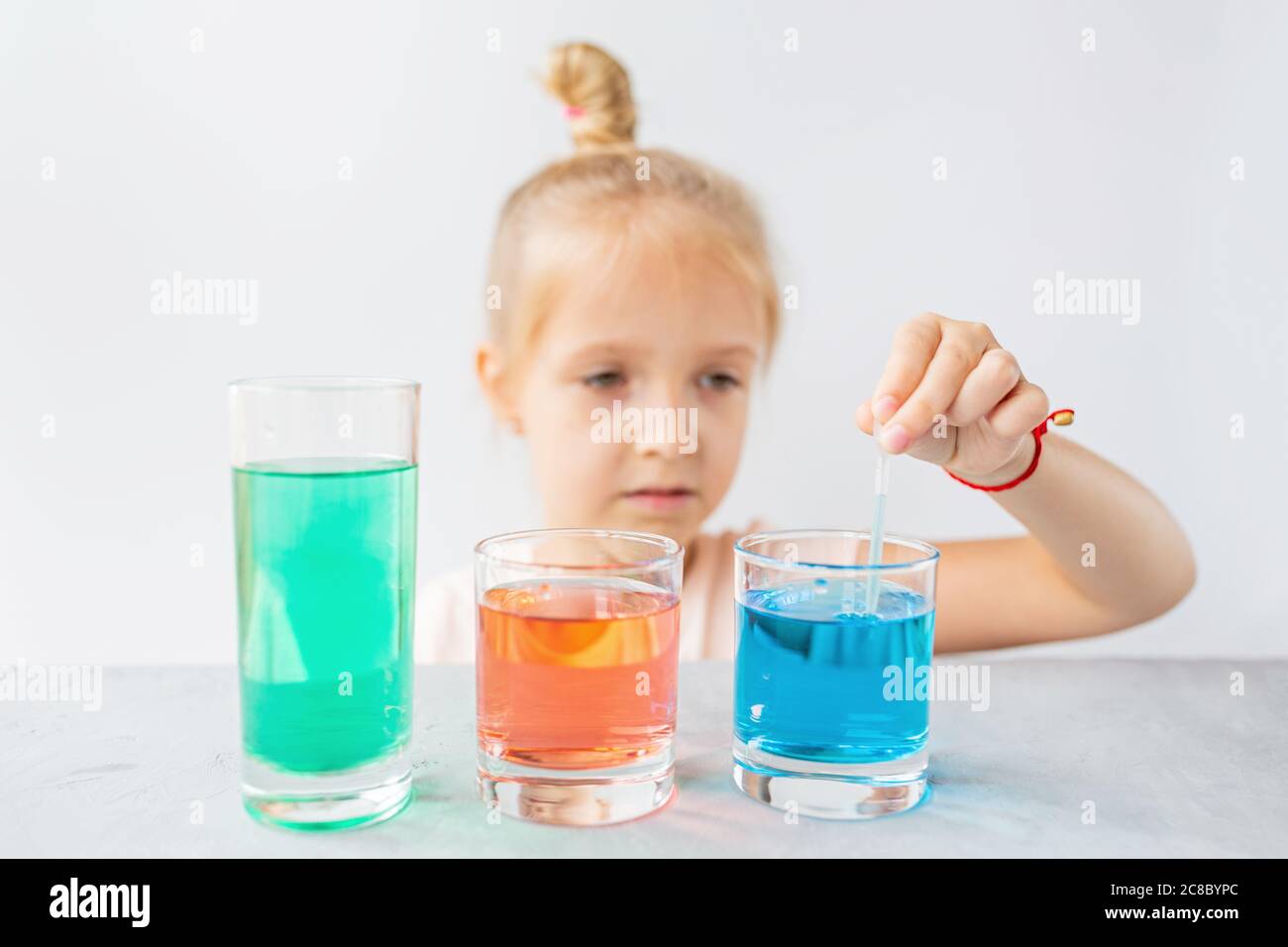 cute little girl six years old doing laboratory experiment with ...