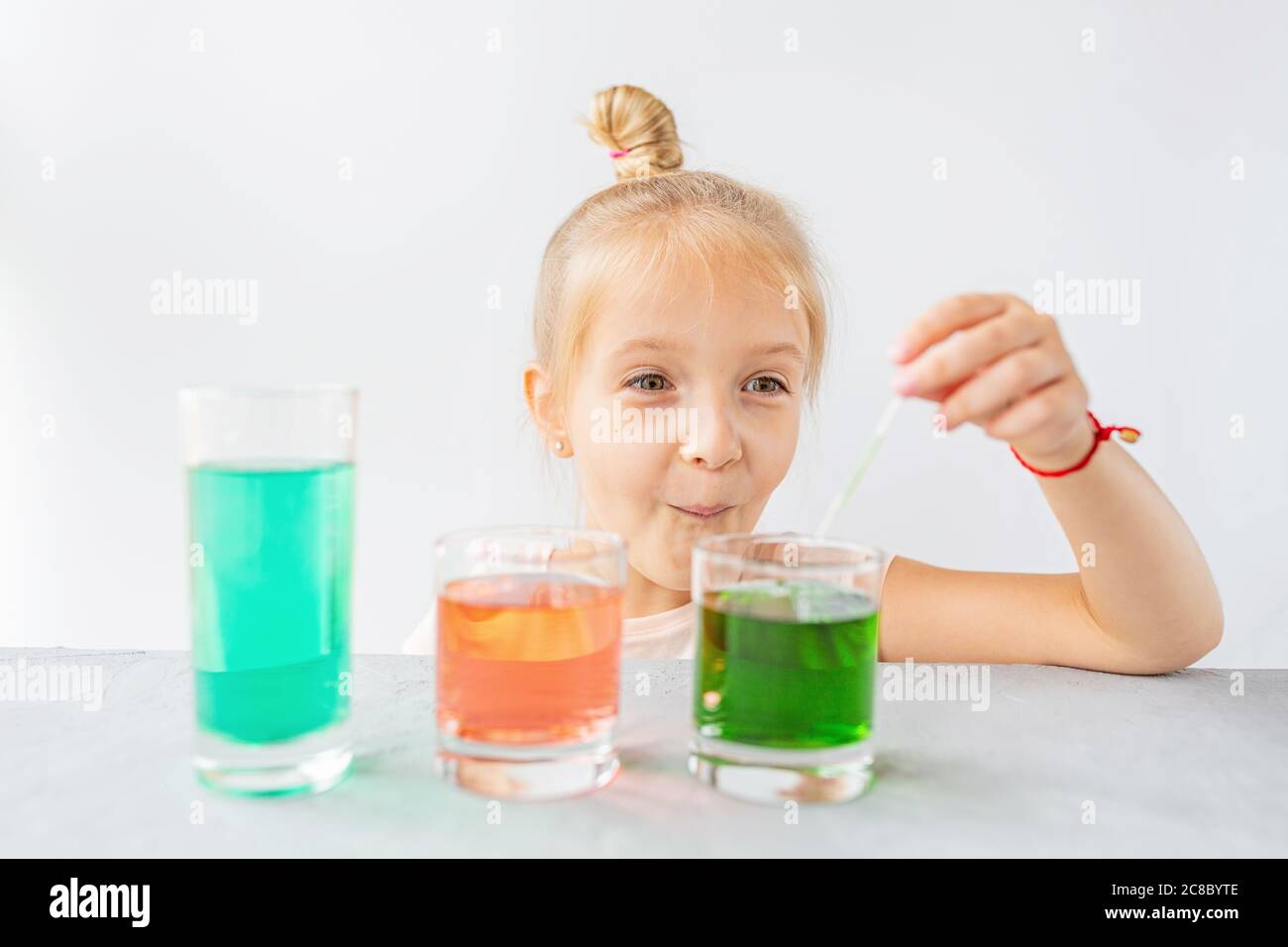 cute little girl six years old doing laboratory experiment with ...