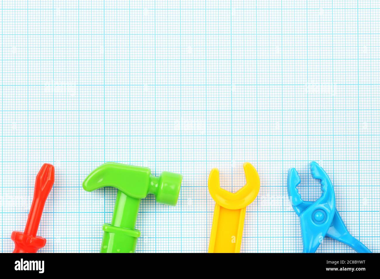 plastic tools on millimeter paper with copy space Stock Photo - Alamy