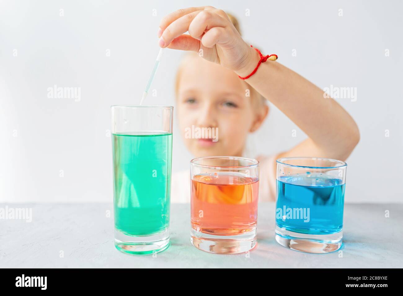 cute little girl six years old doing laboratory experiment with ...