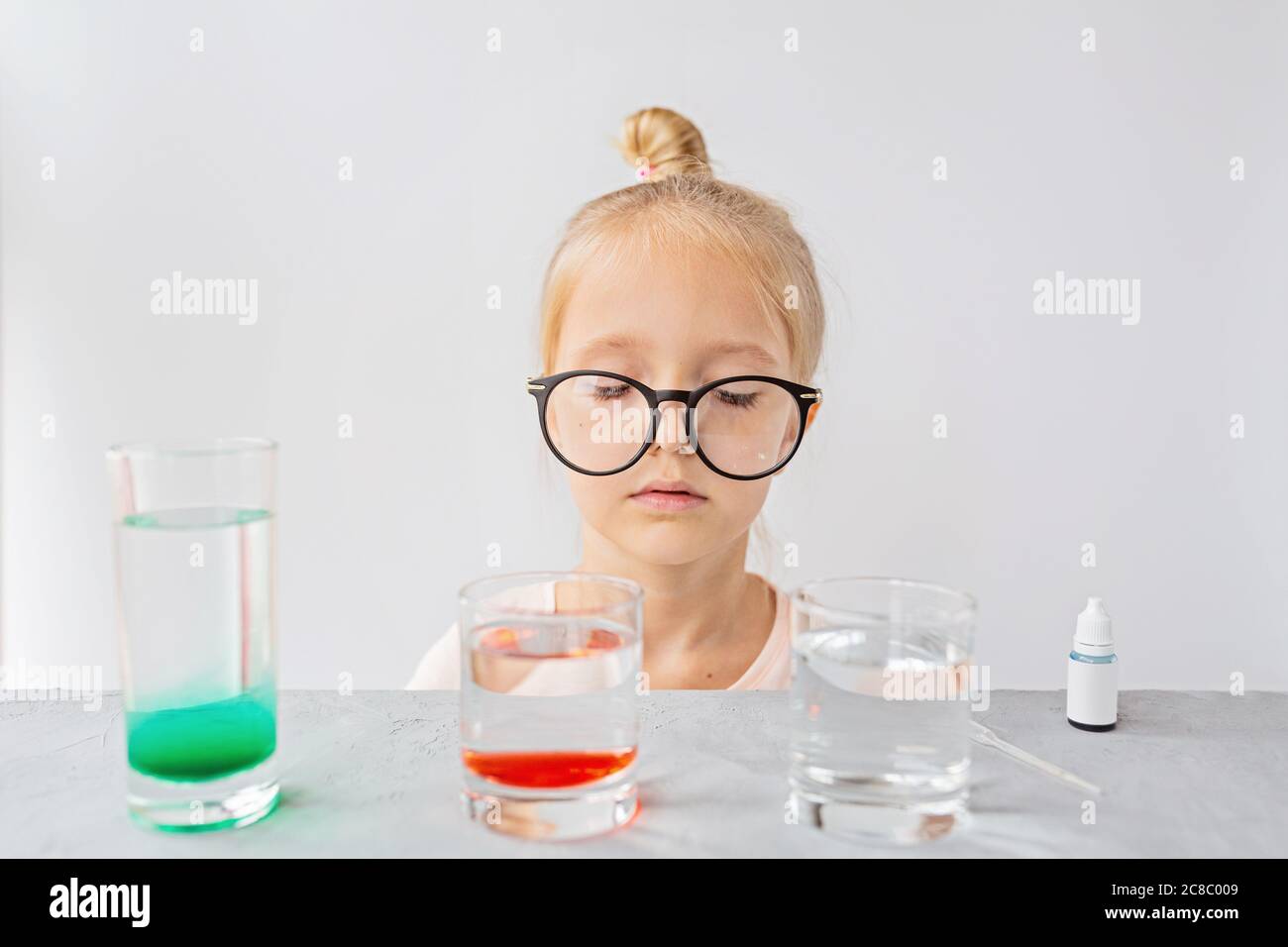 cute little girl six years old doing laboratory experiment with ...