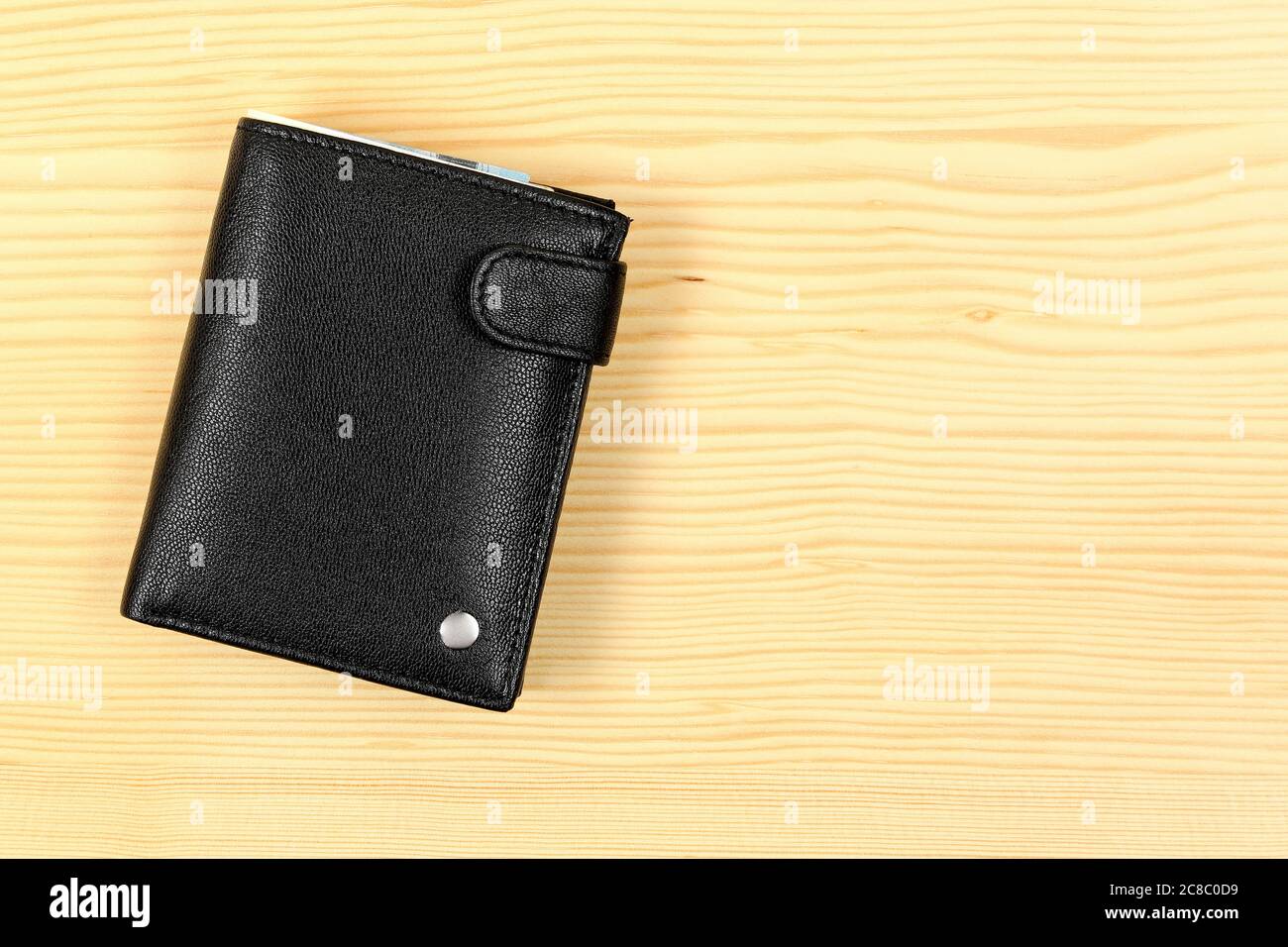 black leather wallet on wooden desk surface Stock Photo - Alamy