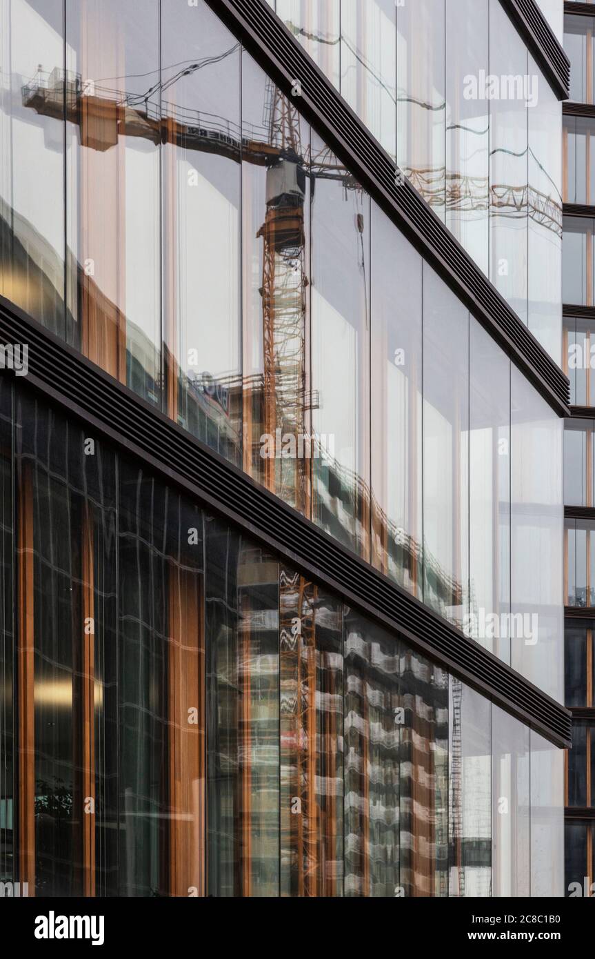 Reflection of construction site in a modern glass building Stock Photo ...