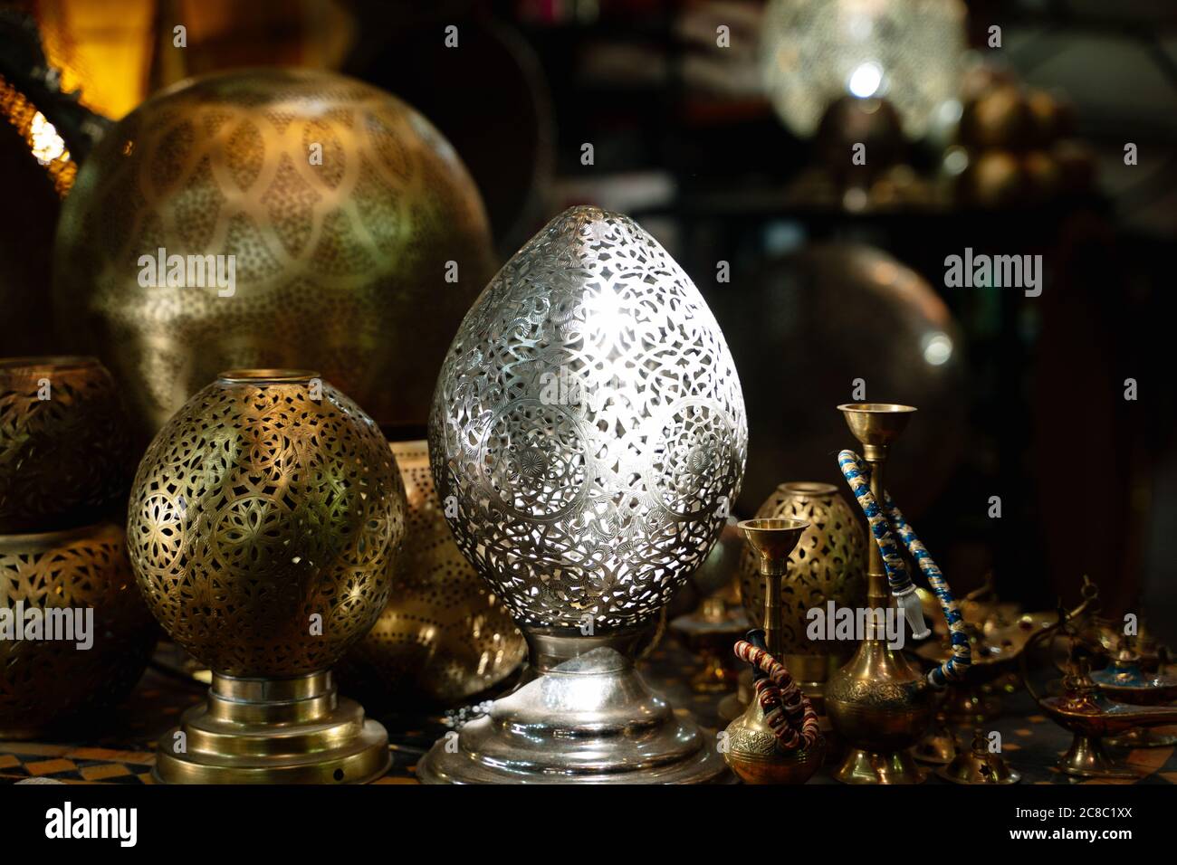 Silver egg-shaped figure next to other bronze figures in a market in ...