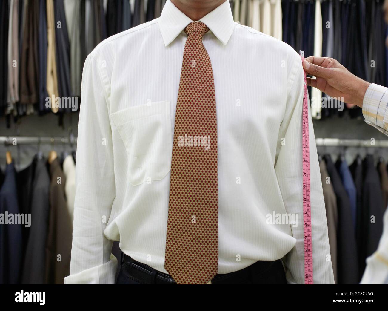Tailor measuring business man for suit Stock Photo - Alamy