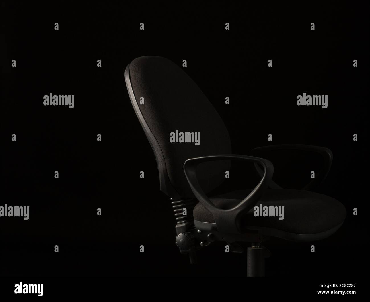 Office chair on black background Stock Photo - Alamy