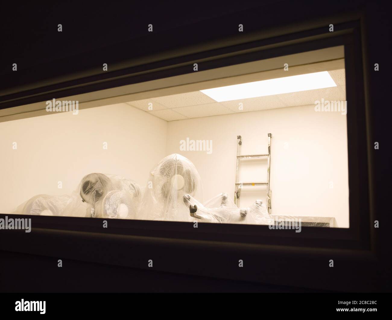 Room filled with things covered in plastic Stock Photo - Alamy