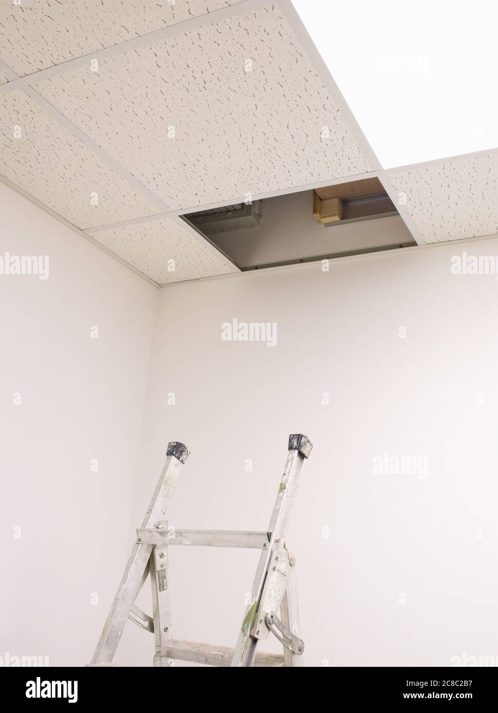 Ladder in Below Open Ceiling Panel in Empty Office Stock Photo - Alamy