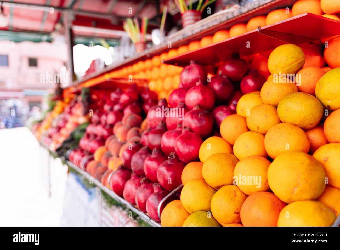 Selective focus on a pile of oranges at a fruit juice stand in the ...