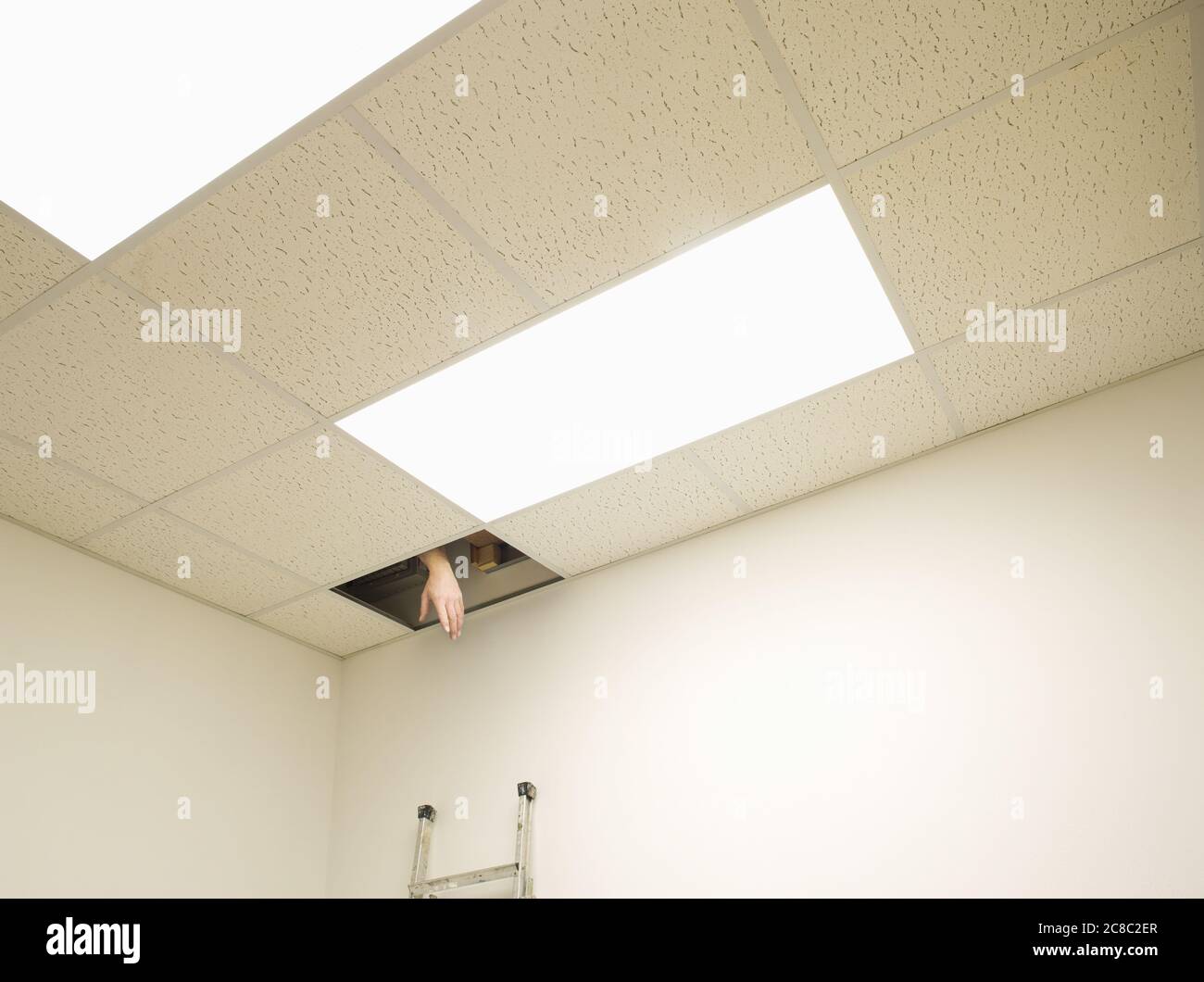 Hand reaching from hole in ceiling Stock Photo - Alamy
