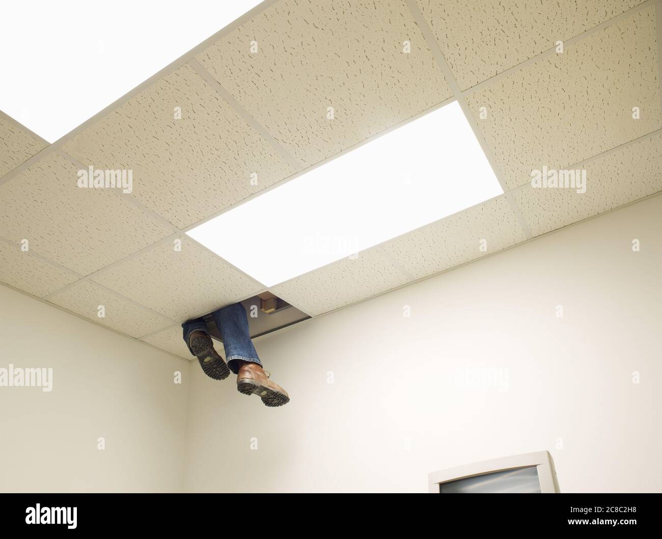 Legs peeping from hole in ceiling Stock Photo - Alamy