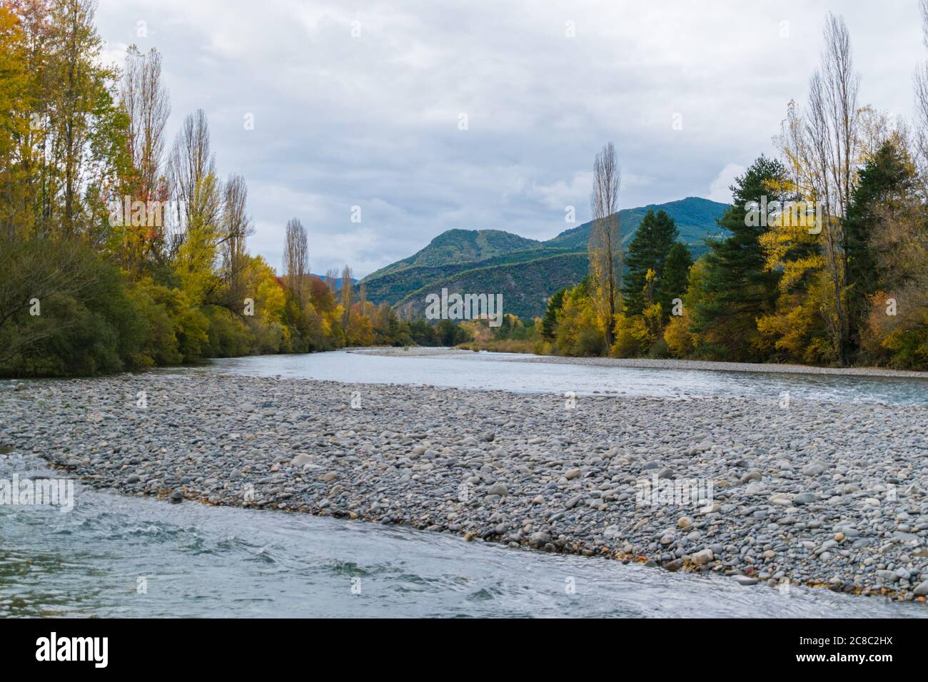 Wide river with enough flow between mountains in autumn Stock Photo - Alamy