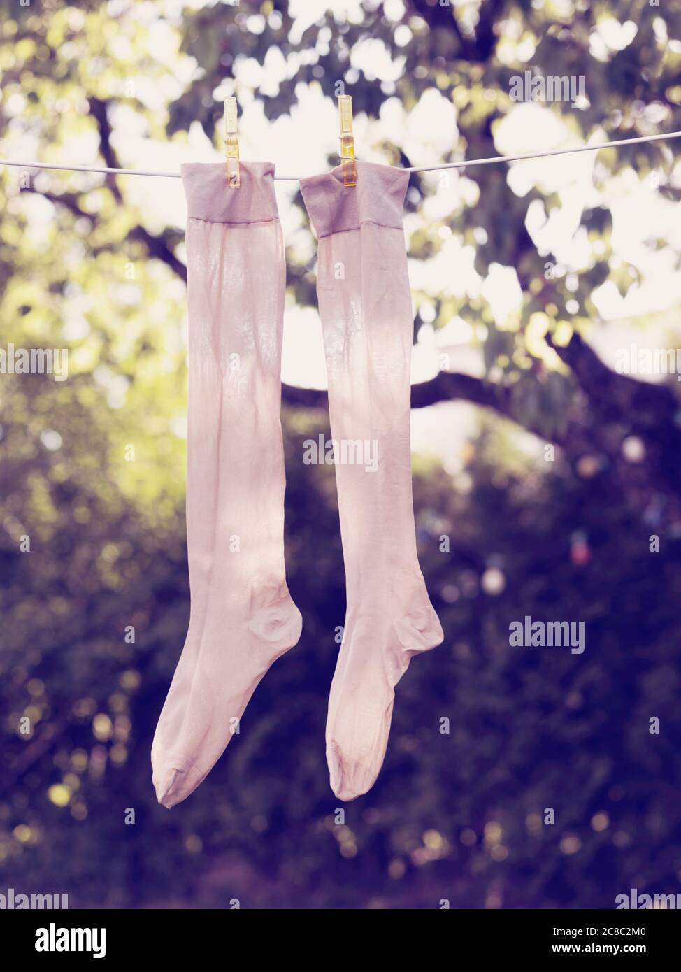 Pair of socks drying on clothesline Stock Photo - Alamy