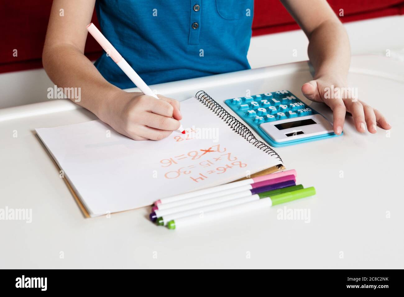 Child doing maths homework using calculator Stock Photo - Alamy