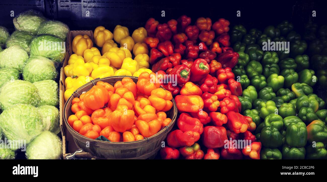 Variety of bell peppers on display for sale in market Stock Photo - Alamy