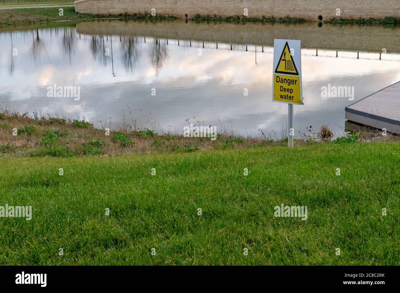 Newly dug pond area at the front of a housing development. A warning ...