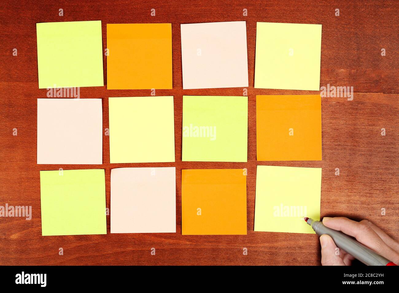 hand with marker writing on blank adhesive notes Stock Photo - Alamy