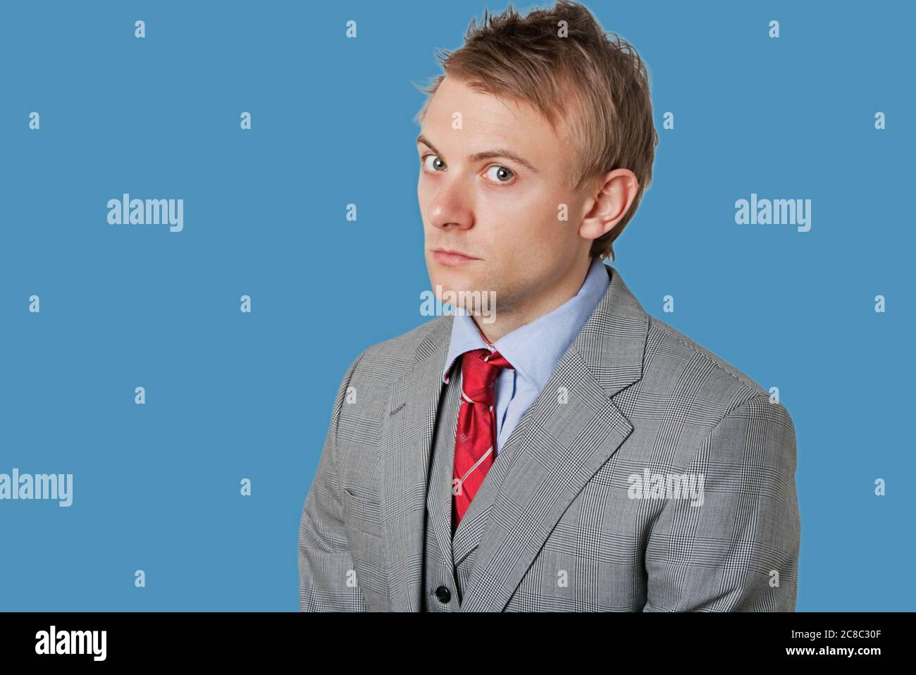 Portrait of angry young businessman wearing grey suit Stock Photo - Alamy