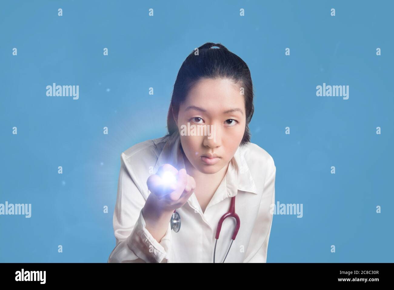 Young Asian female doctor holding a flashlight Stock Photo - Alamy