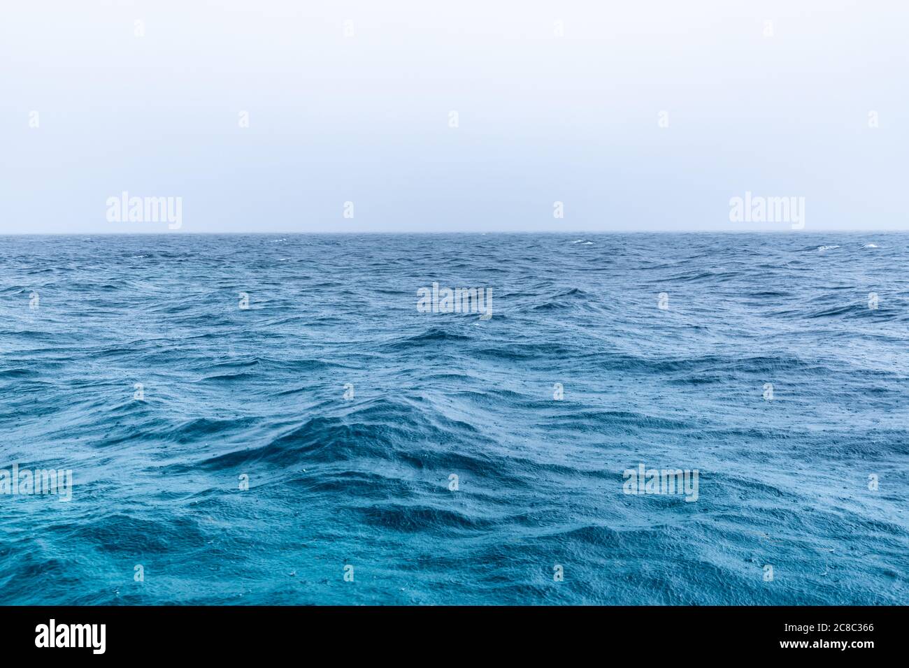 Rain on sea, small waves, ripples. Seascape with endless horizon. Clear ...