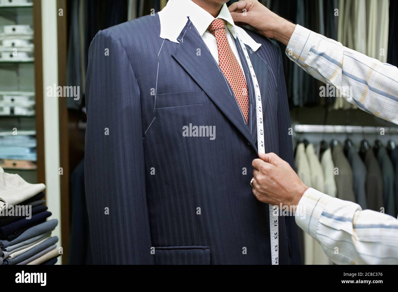 Tailor measuring business man for suit Stock Photo - Alamy