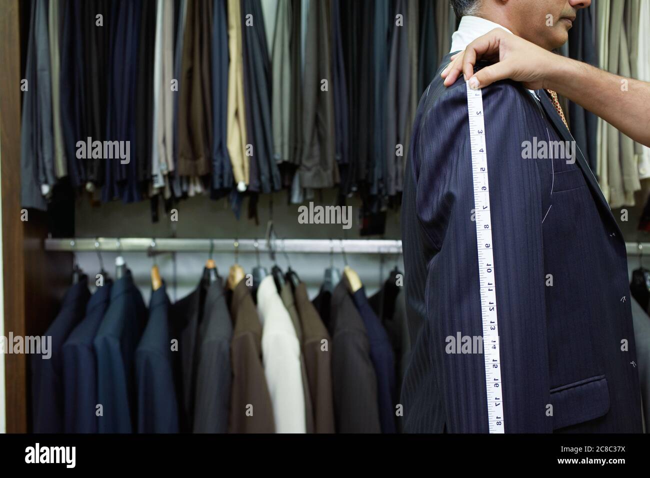 Tailor measuring business man for suit Stock Photo - Alamy