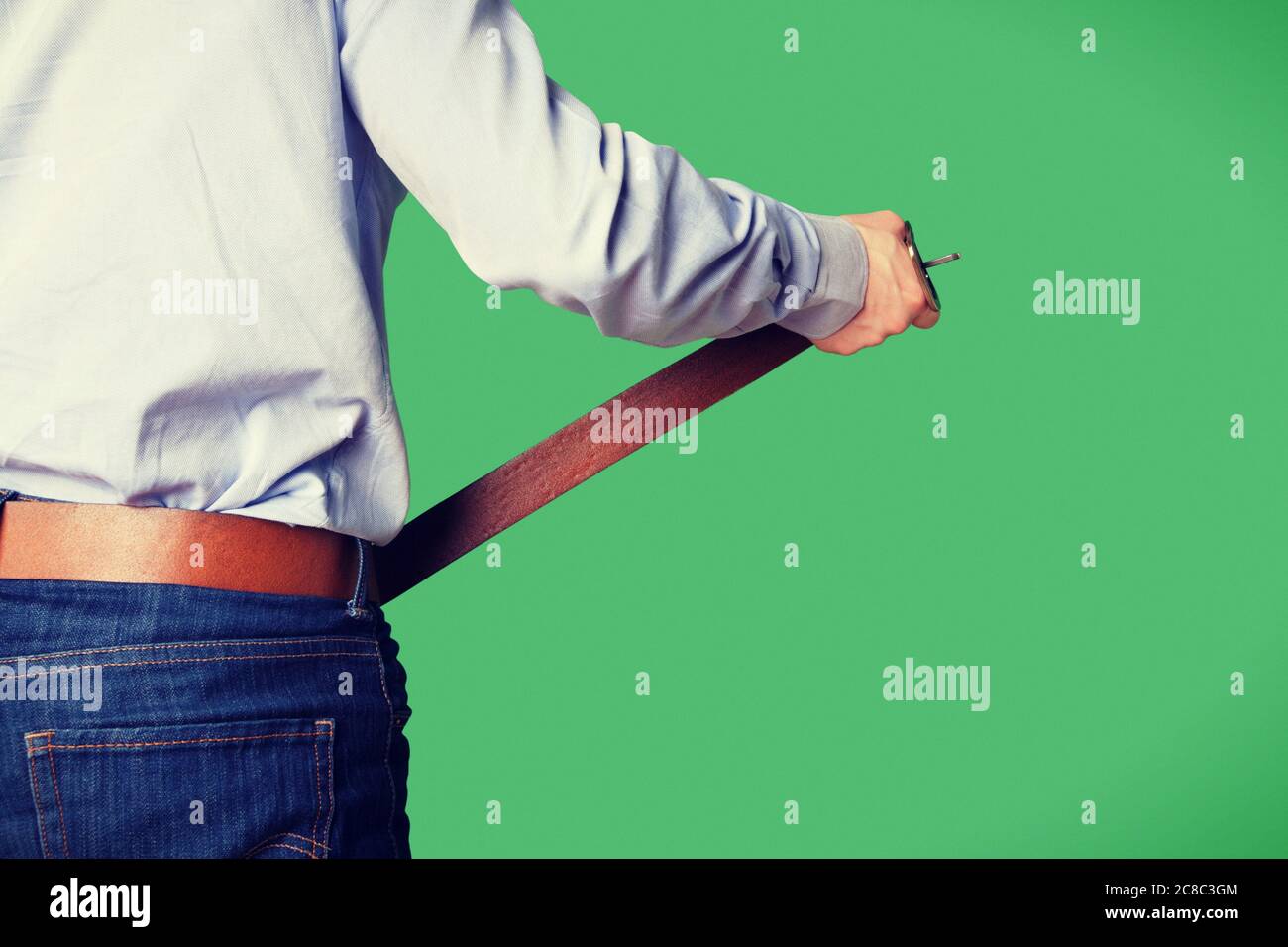 Man tightening his brown belt Stock Photo - Alamy
