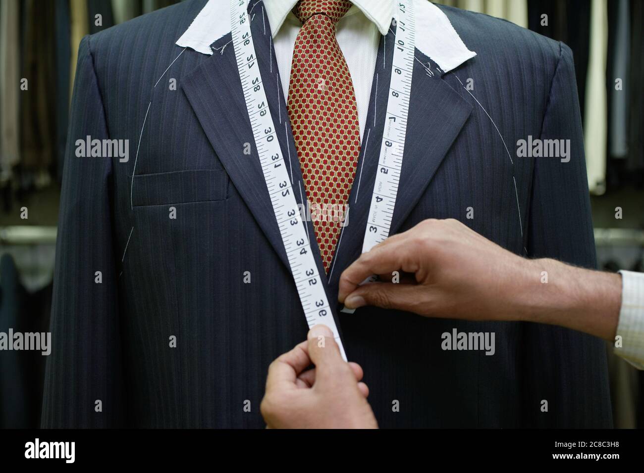 Tailor measuring business man for suit Stock Photo - Alamy