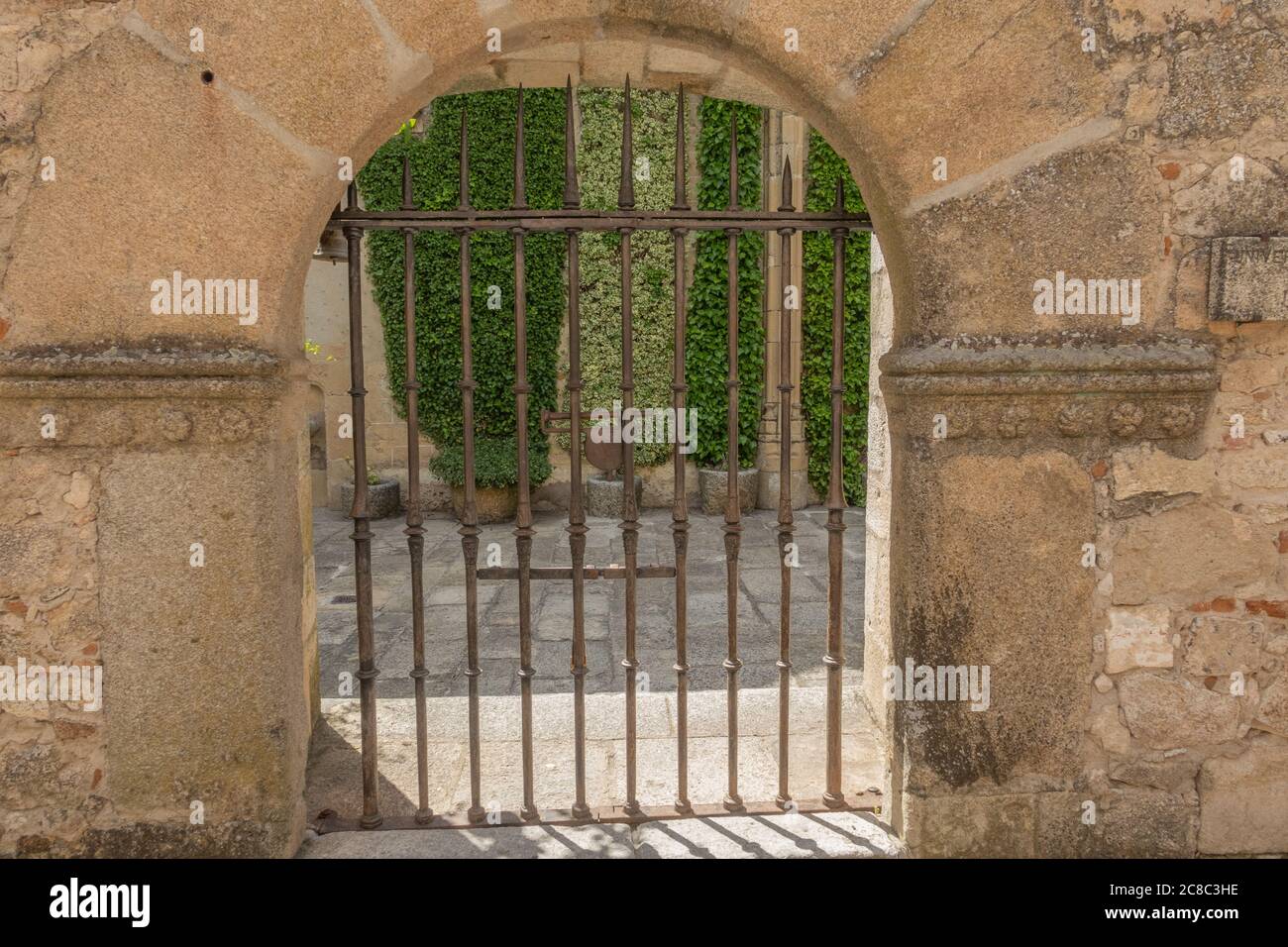 Small stone arch with a gate in Trujillo, Spain Stock Photo - Alamy