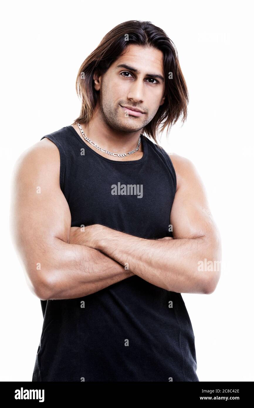 Attractive indian man with arms folded in studio Stock Photo - Alamy