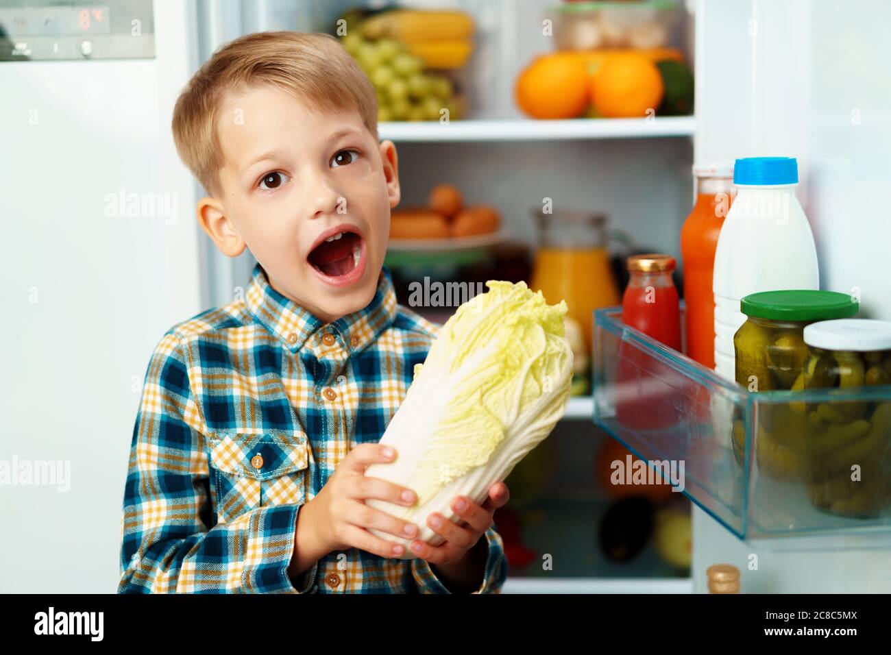 Boy standing in front of open fridge hi-res stock photography and ...