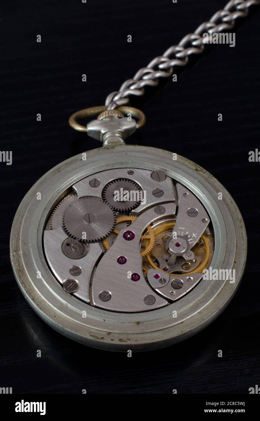 Mechanism of old pocket watch on a black background Stock Photo - Alamy