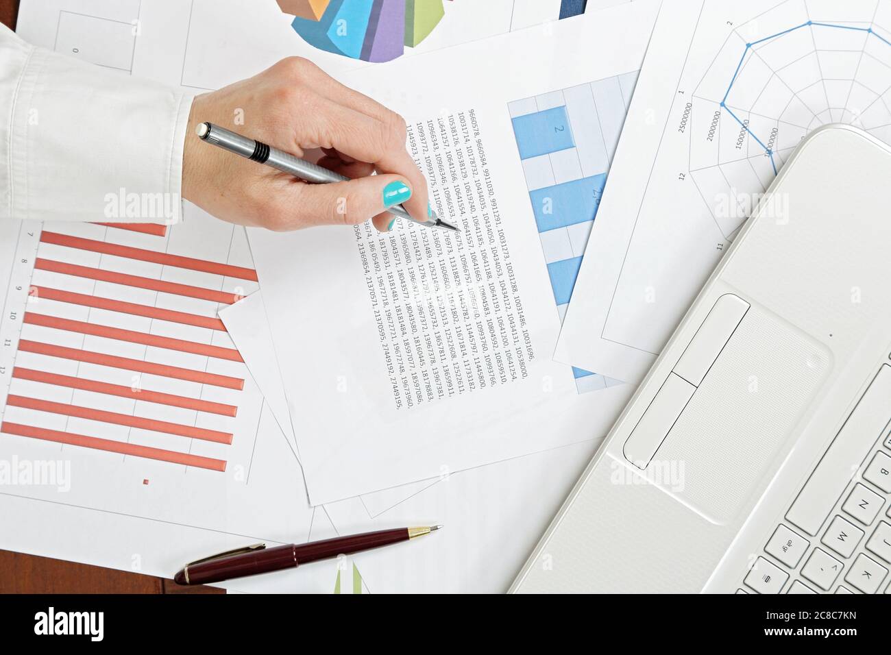 woman is analysing graphs and graphs Stock Photo - Alamy