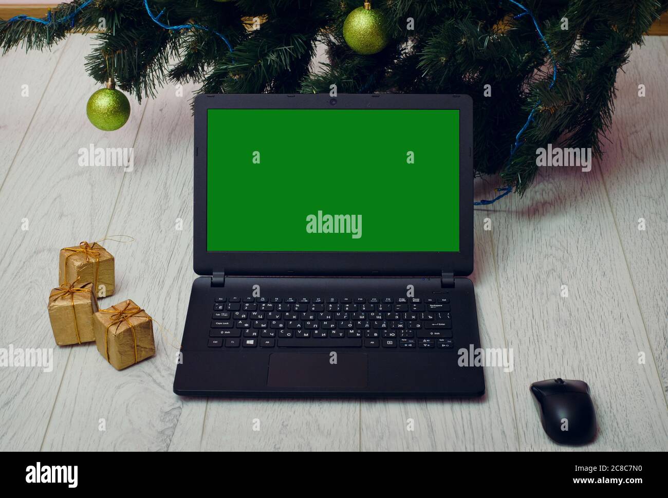 Laptop with a mouse under the Christmas tree Stock Photo - Alamy